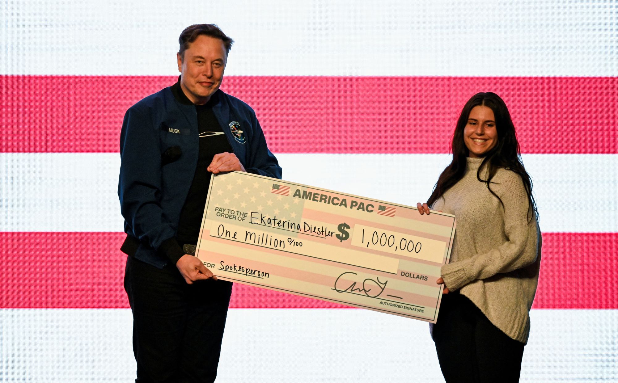 Elon Musk hands over million-dollar cheques to voters at rally