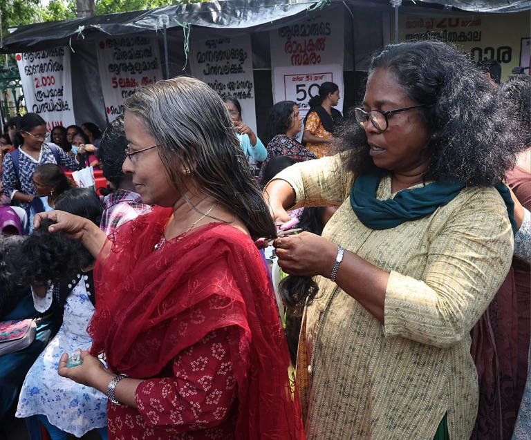 ASHA workers cut hair to mark 50th day of protest against Kerala government