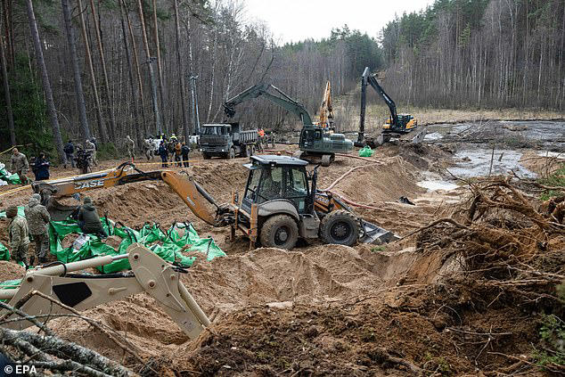US armoured vehicle hauled out of swamp in search for missing soldiers