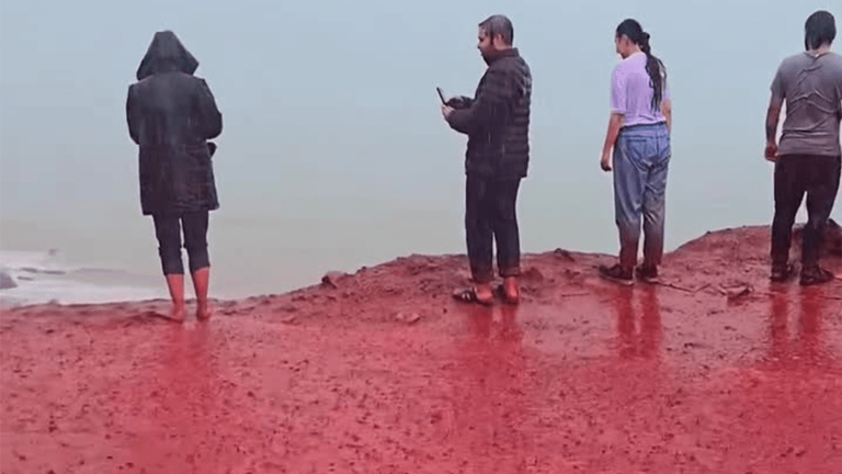Tourists Watch As The Sea Turns Blood Red On The Iranian Island Of Hormuz