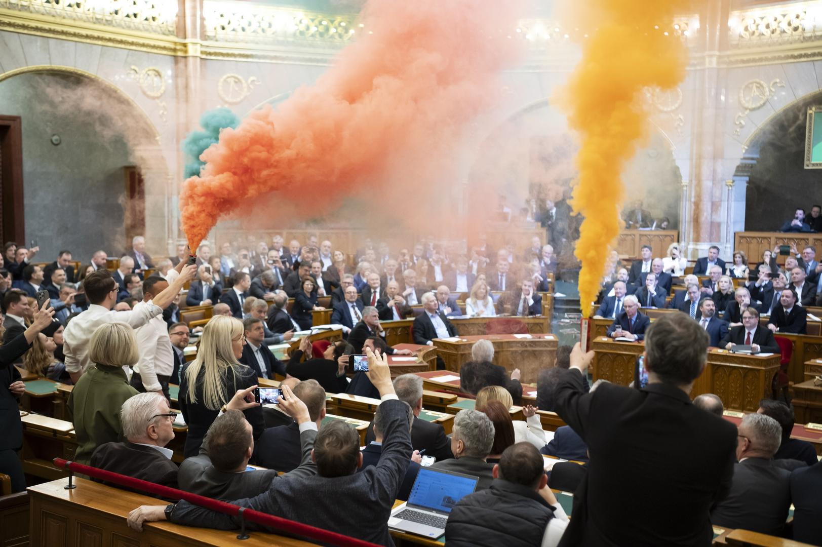Opposition lawmakers in Hungary ignite smoke bombs as parliament passes ...