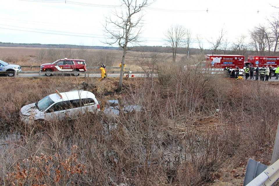 Officer rescues 2 kids, driver after school van veers off road into marsh