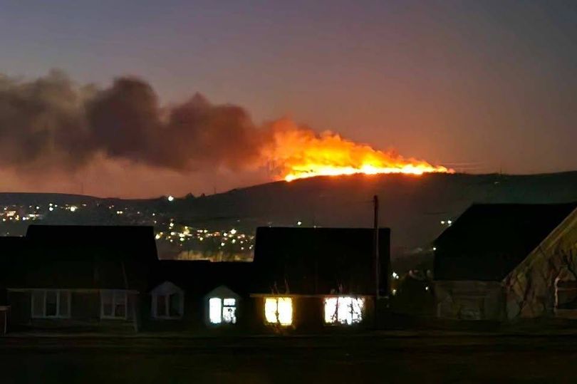 Huge mountain fire seen for miles as emergency services rush to scene