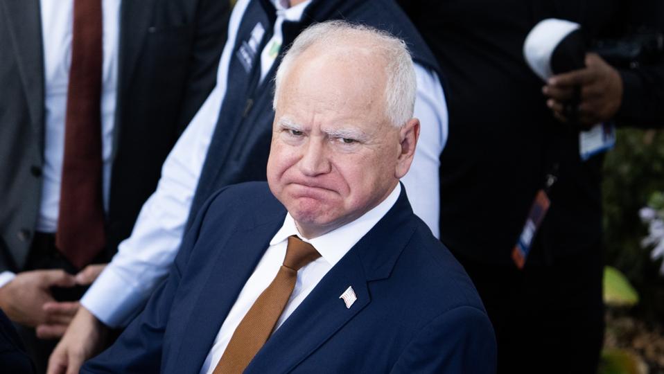 Elon Musk And Tim Walz Exchange Barbs As Walz Celebrates Tesla Stock Slide