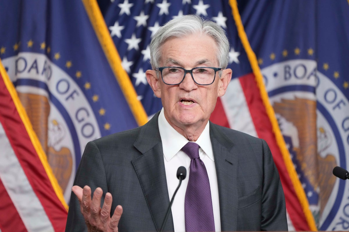 Federal Reserve keeps interest rate unchanged, sees slower growth ...