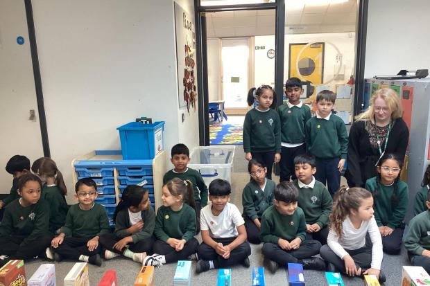 School built giant domino chain of cereal boxes in support of local charity
