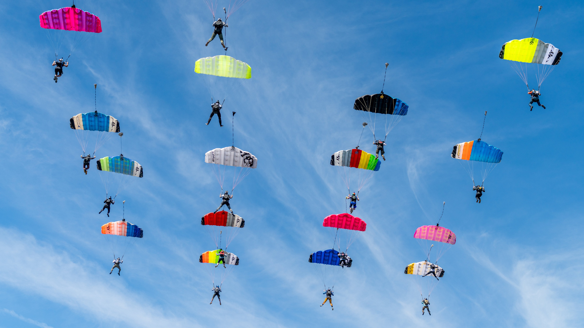 Group of 20 skydivers perform dazzling displays with deployed ...