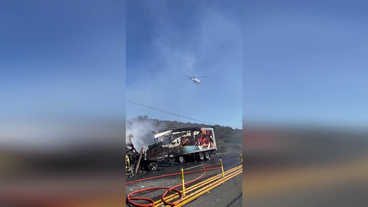 Helicopter dumps water on remnants of Sycamore Fire in California
