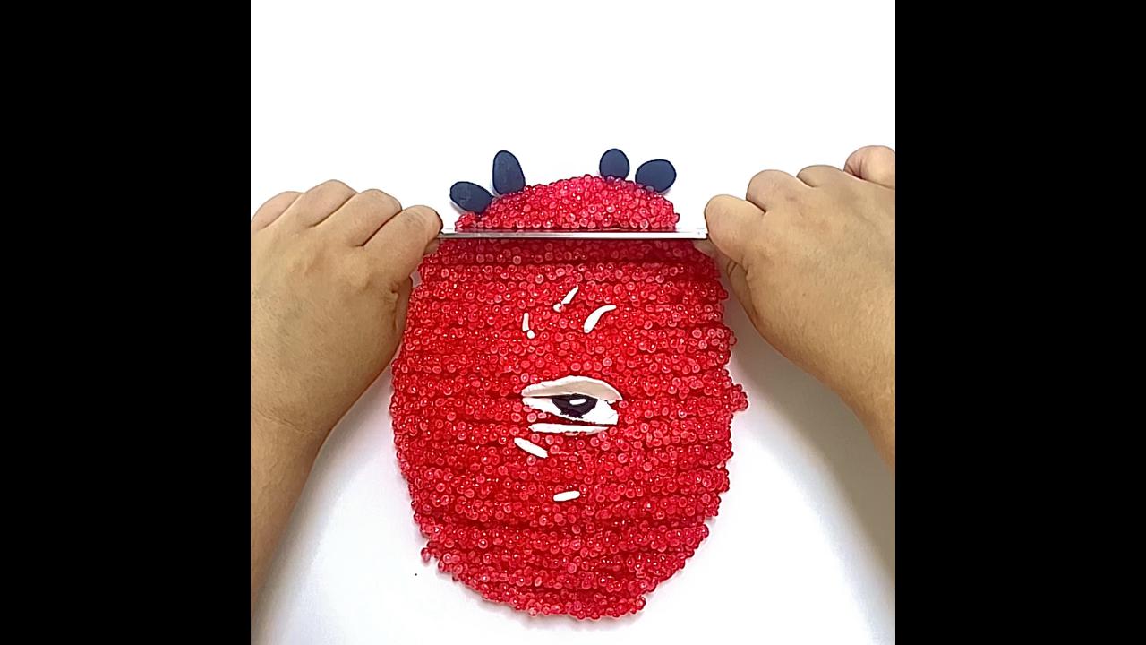 Cutting A Red One Eyed Monster Crunchy Clay With Beads
