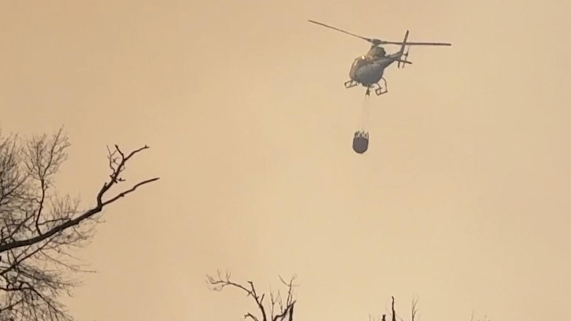 Texas firefighters use helicopters to dump water on Pauline Road fire