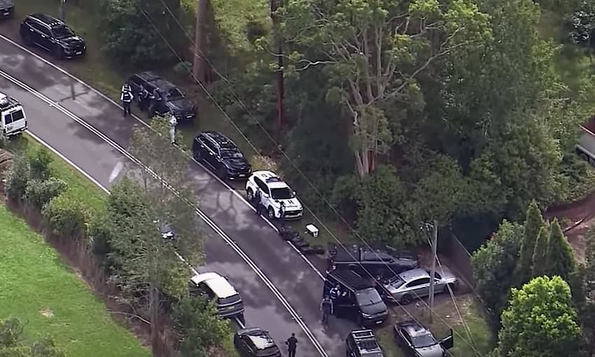 Tactical police swarm house in unfolding major police operation