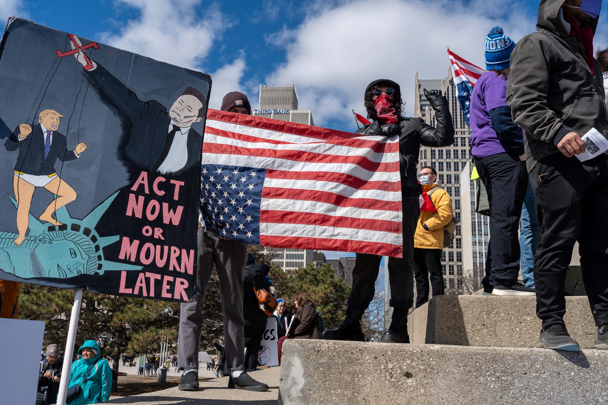 Protesters in Detroit and Canada unify across river, rally against ...