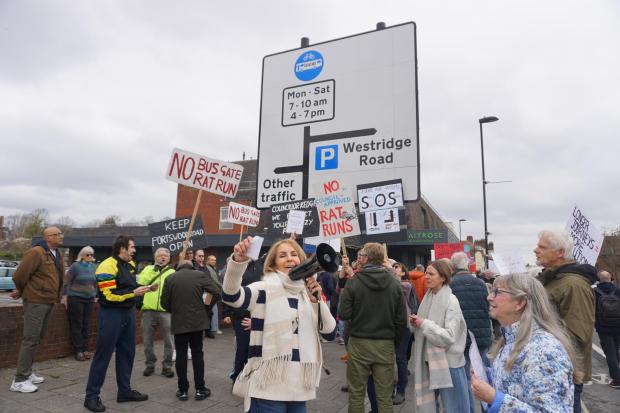 Hundreds of angry residents march to protest controversial bus gate