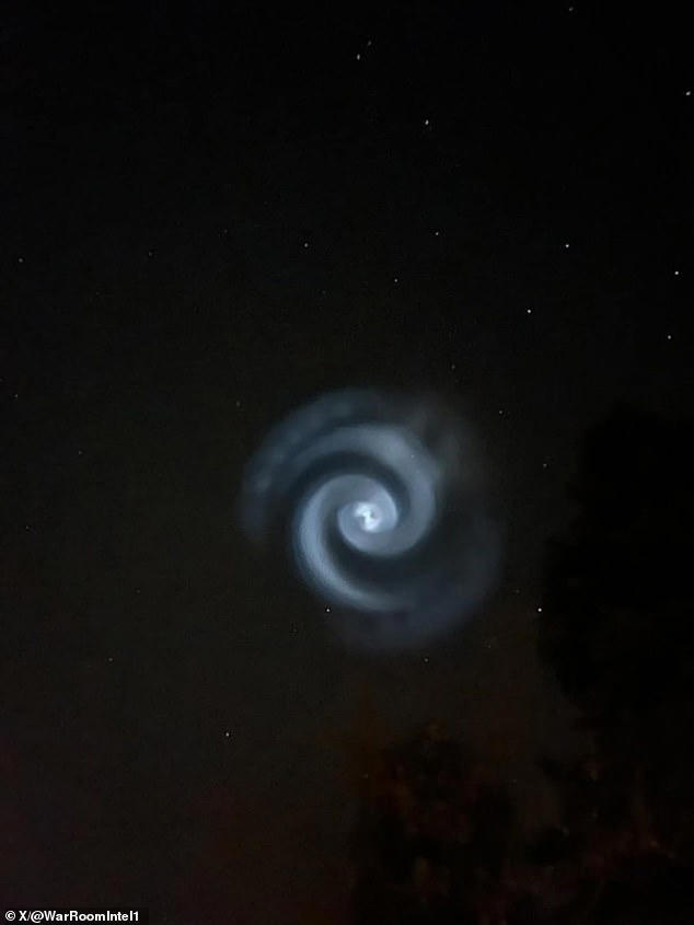 Mystery as huge spinning spiral spotted in the skies above Britain