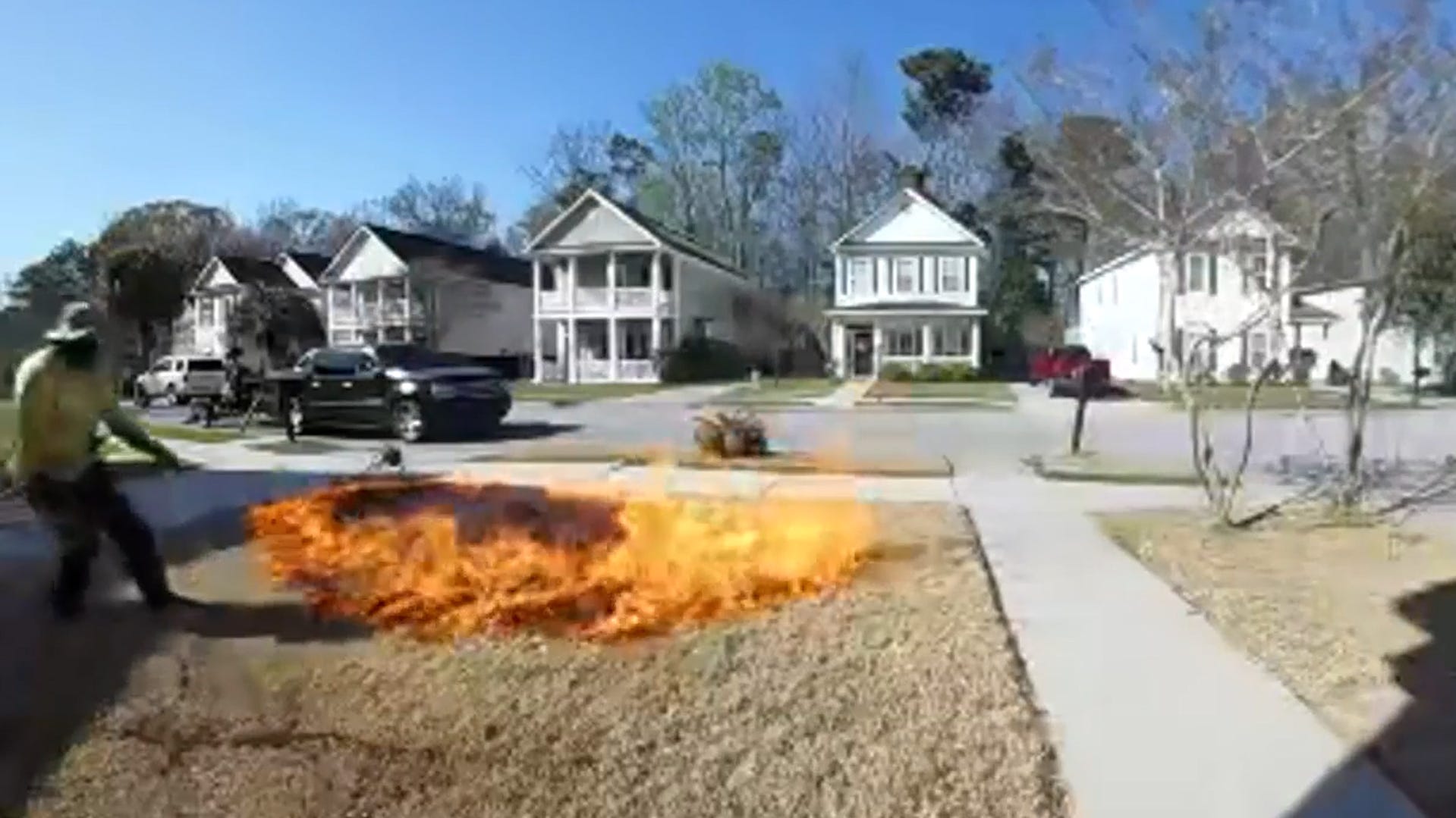 Simple spark quickly ignites fire on dry grass outside of a South ...