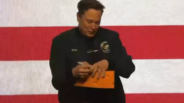 Musk signs cheese hat before check handouts in Wisconsin vote