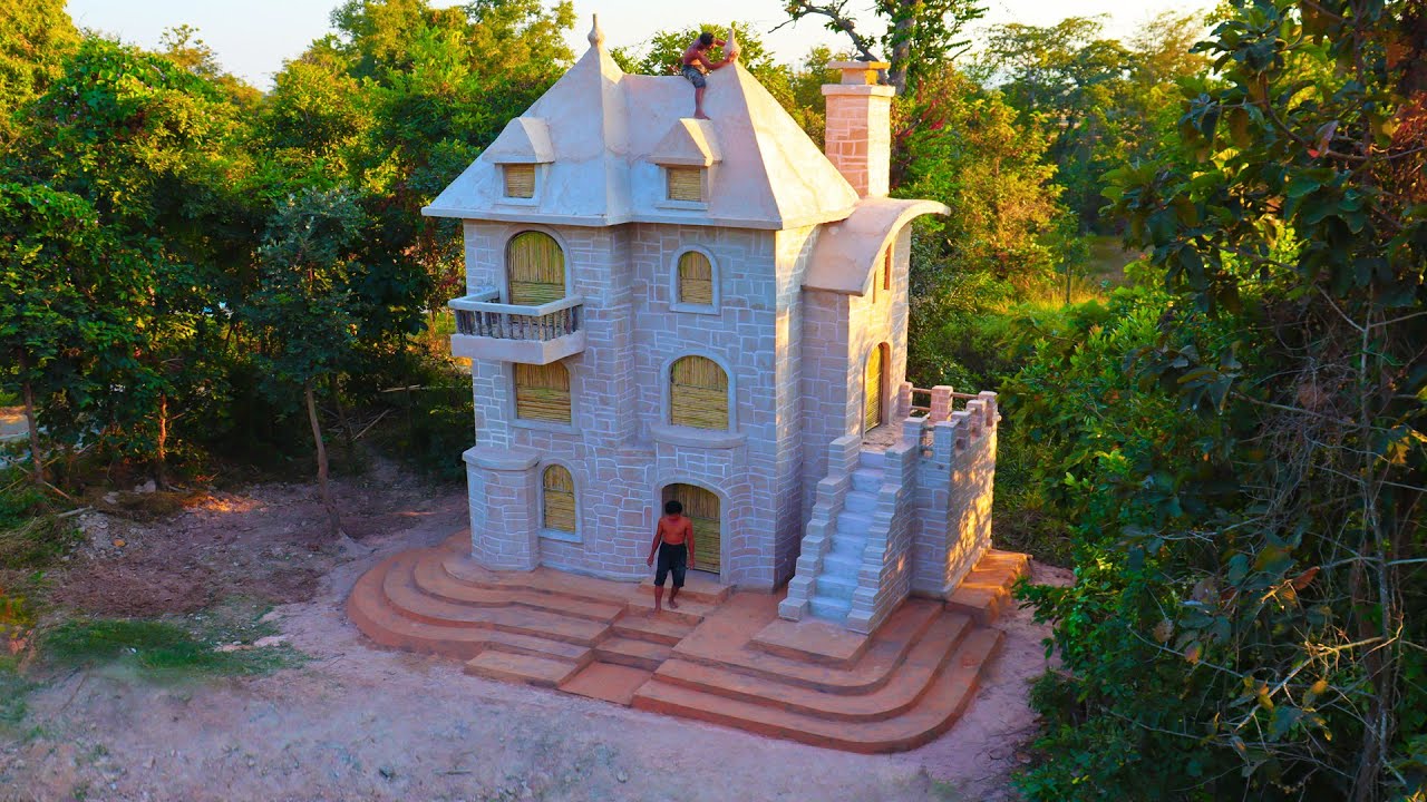 A zero-cost classic villa built by hand rising in the forest that ...