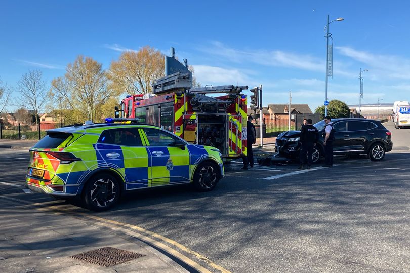 Busy junction closed after car crashes into traffic lights