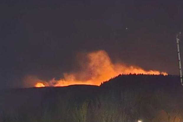Fire crews tackle ongoing hillside blaze at popular walking spot