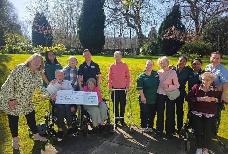 Care home presents cheque to local charity
