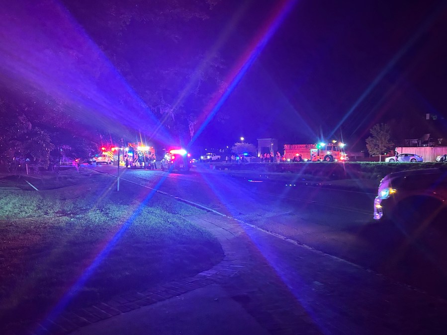 Driver hospitalized after vehicle flips and lands underwater in Baton Rouge