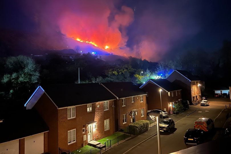 Firefighters battle large mountain blaze through the night close to ...