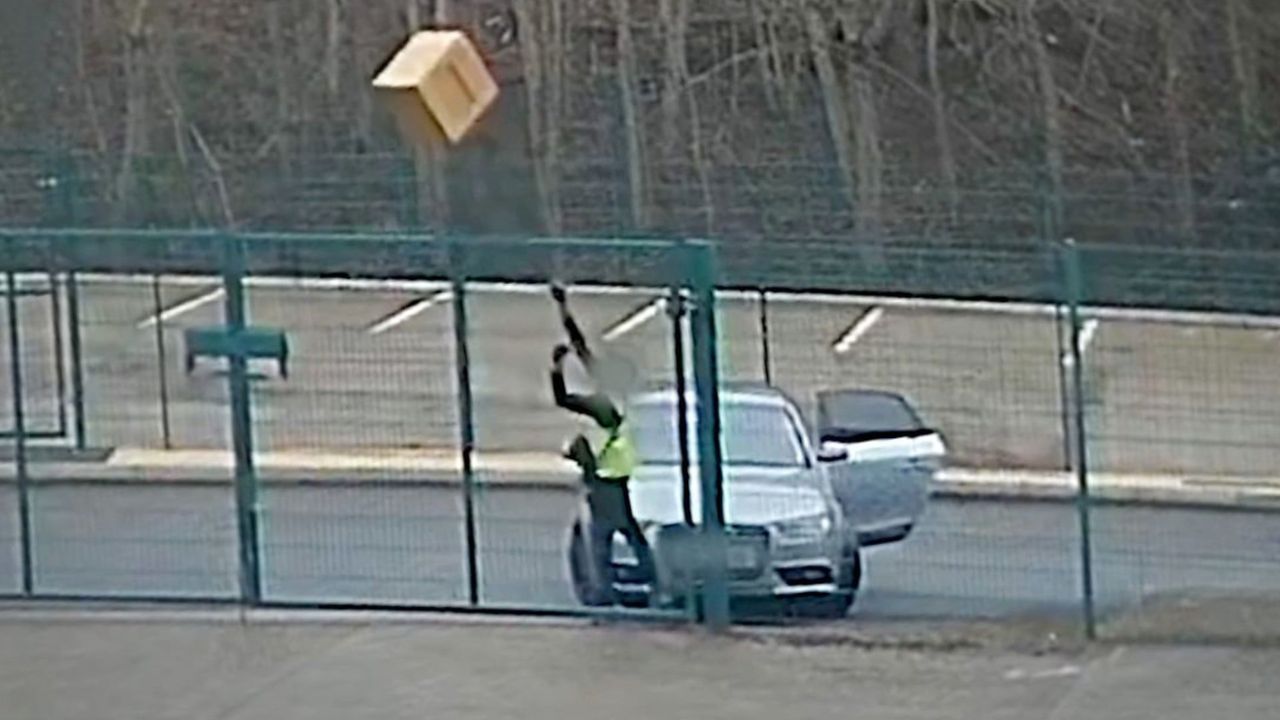 Air mail! Inconsiderate delivery driver hurls fragile package over fence