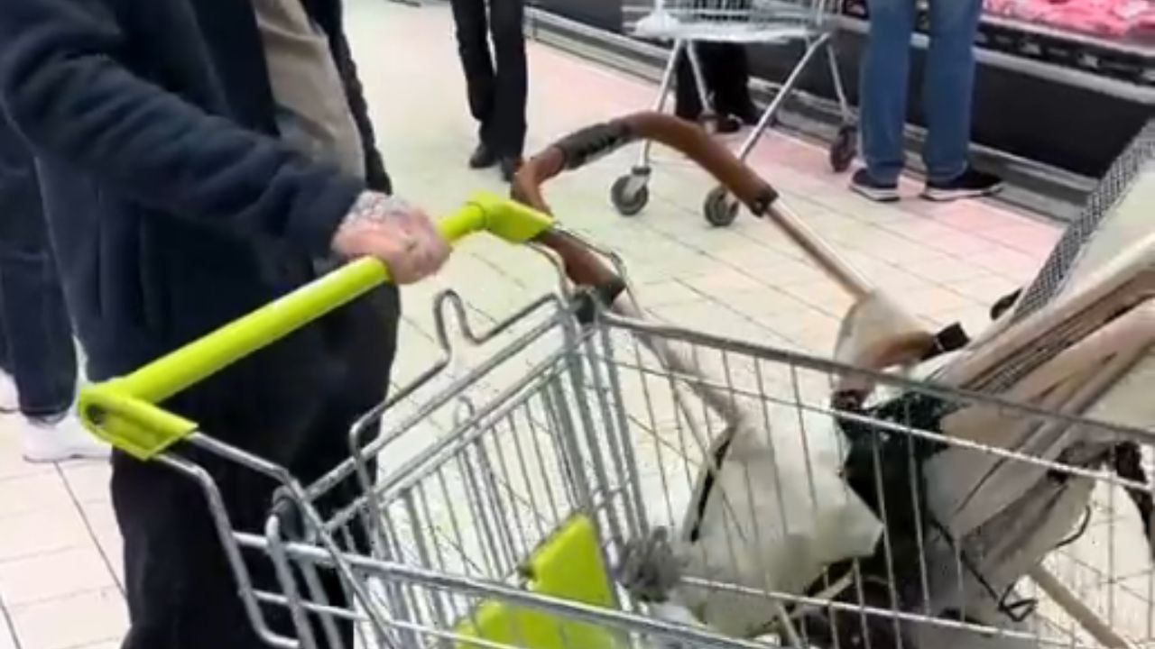 Man absentmindedly moves the cart while baby waits in the stroller