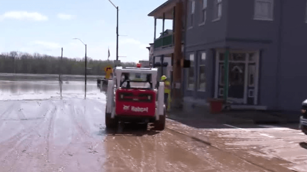 Crews in Aurora clean up mud left behind by receding floodwaters