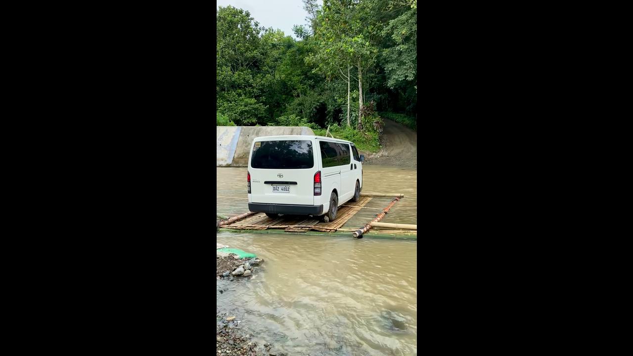 Locals build bamboo raft to carry cars across river in the Philippines