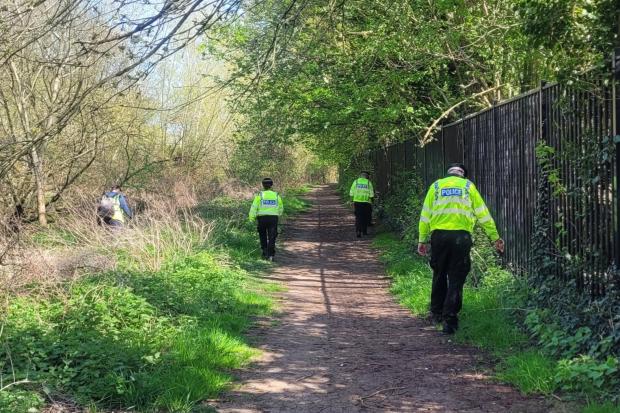 Police officers scour and search park after 'stabbings'