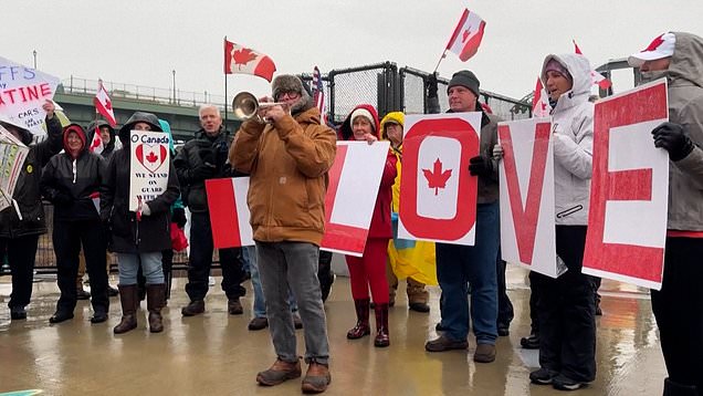 Americans wave Canadian flags as they protest Trump tariffs