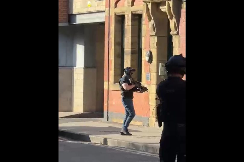 Armed police pictured blocking off city centre street as GMP issue ...
