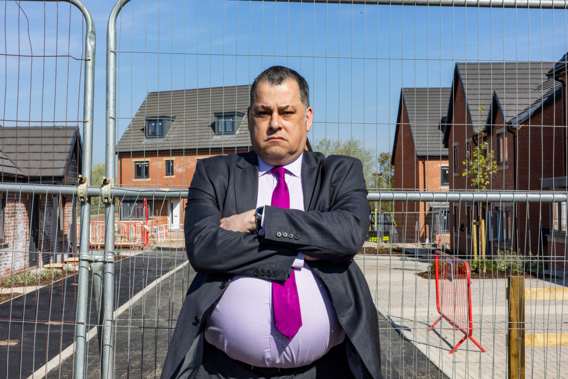 Furious landowner clashes with developers over a two-brick high wall