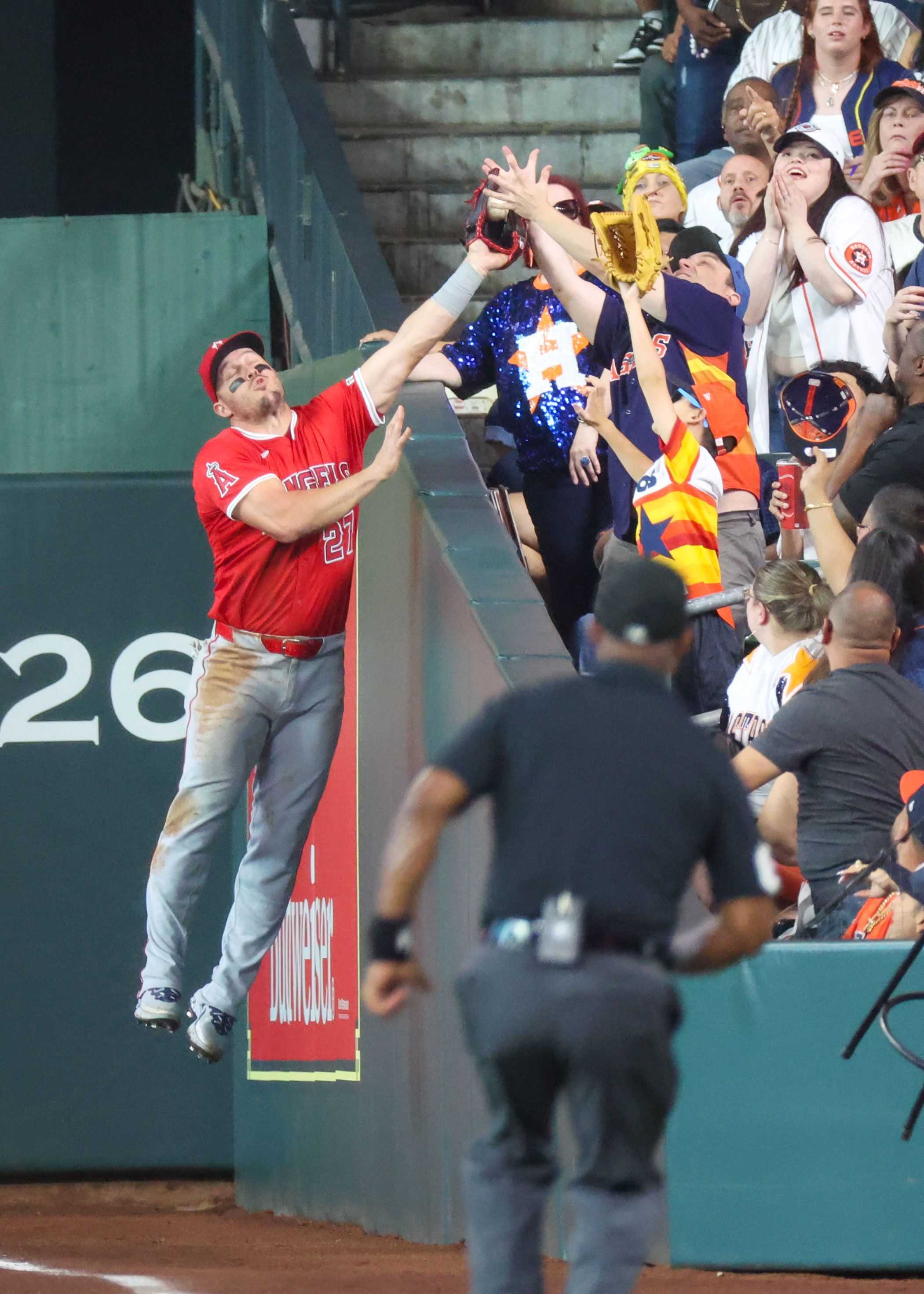 Fan controversially rips ball from Mike Trout's glove