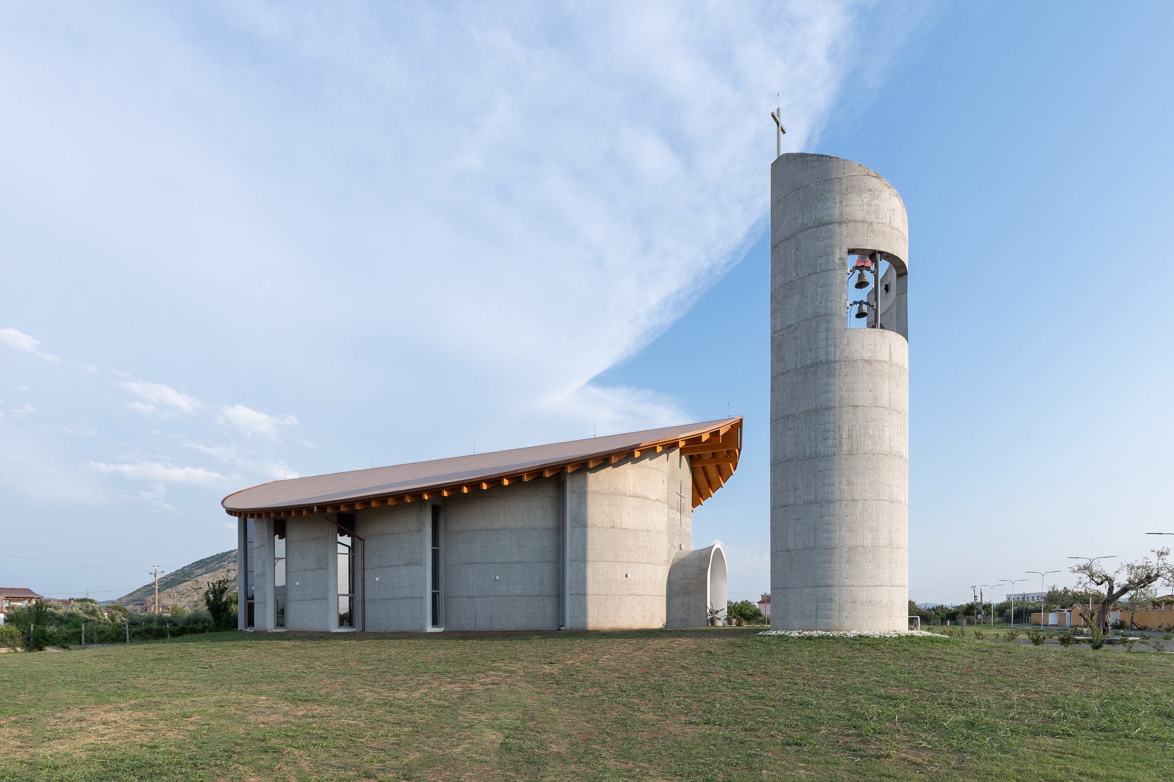 Arkpro Studio designs concrete church in Albania as "new village centre"