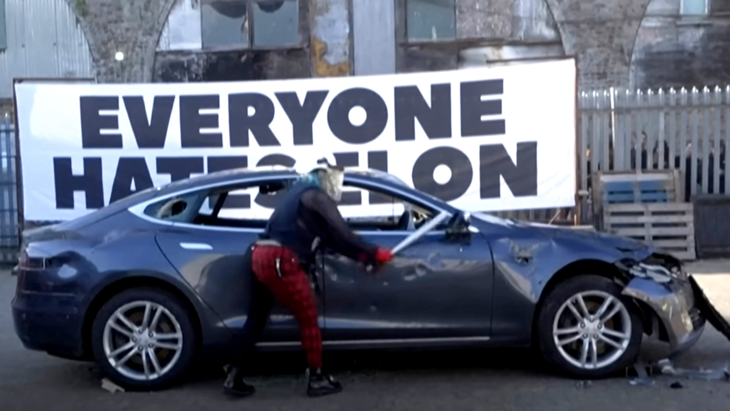 Furious Protesters Smash A Tesla To Pieces In ‘Everyone Hates Elon’ Event