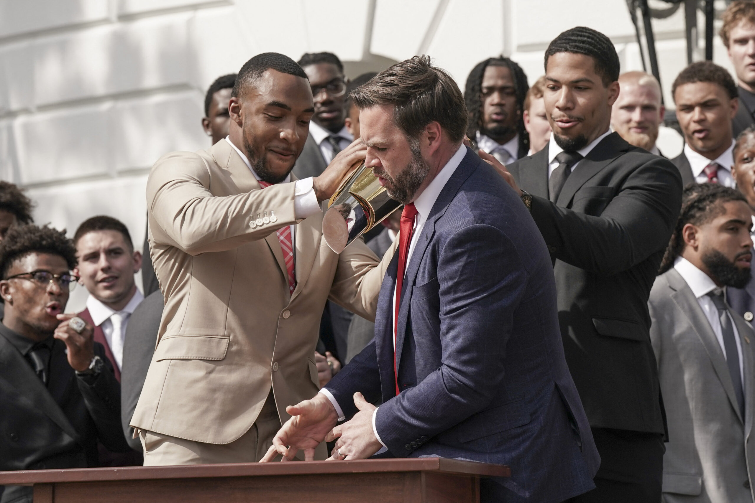 Vance Inspires Jokes by Fumbling Championship Trophy