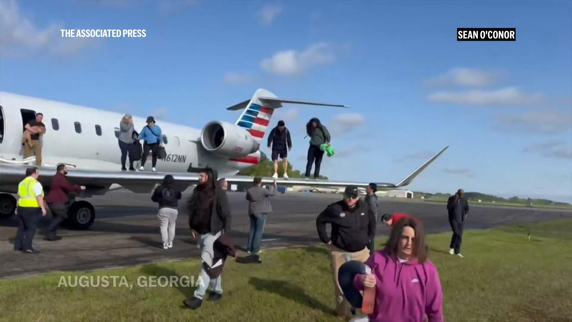 Passengers on American Airlines flight evacuated from wing of plane in ...