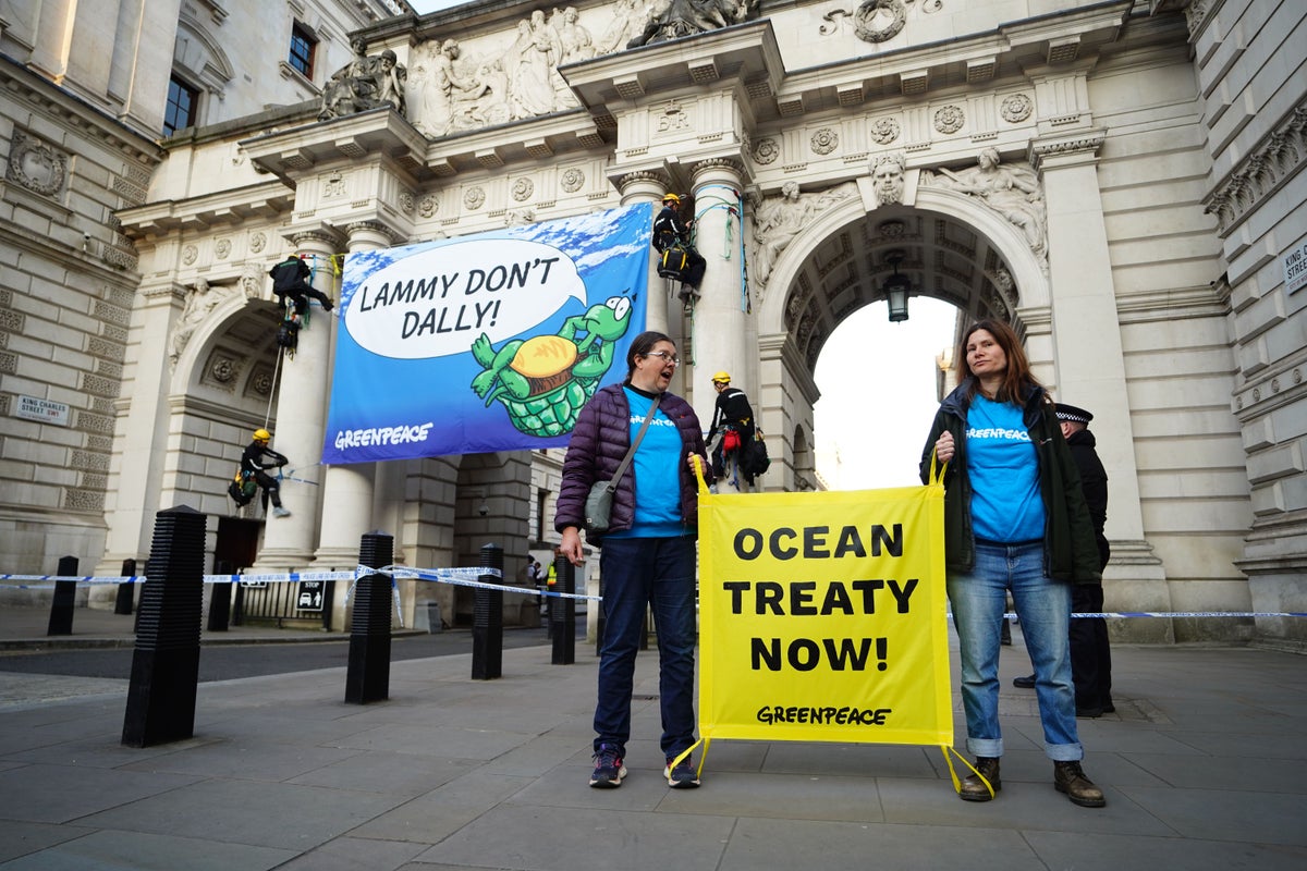 Greenpeace activists climb Foreign Office building over signing of ...