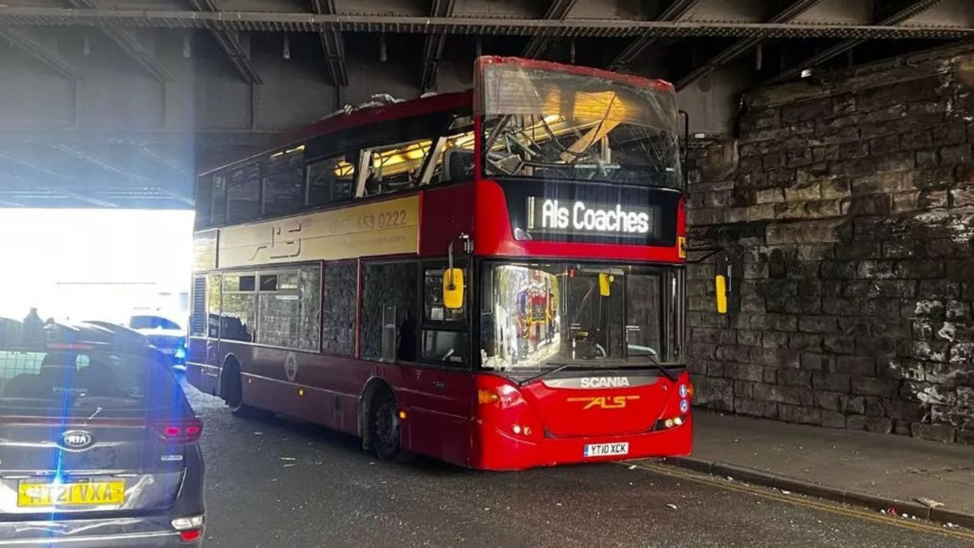 Double decker bus roof ripped off after crashing into bridge