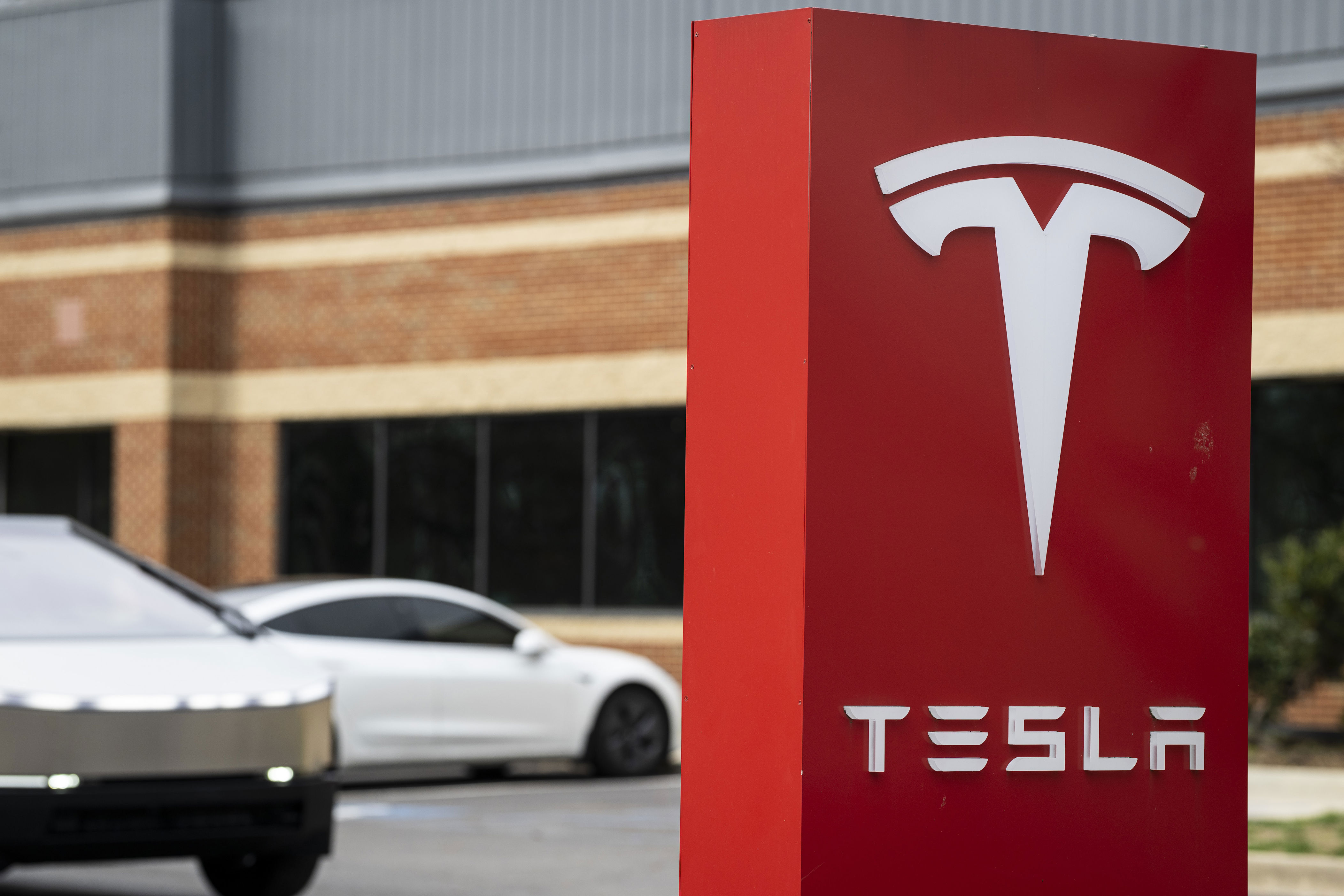 Clean energy exec, ex-federal worker charged with defacing Tesla vehicles