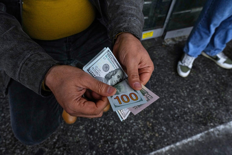 Iran's currency falls to a record low against the dollar as tensions ...