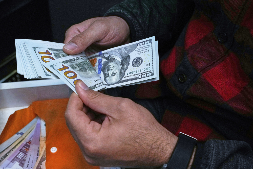 Iran's currency falls to a record low against the dollar as tensions ...