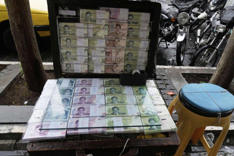 Iran's currency falls to a record low against the dollar as tensions ...
