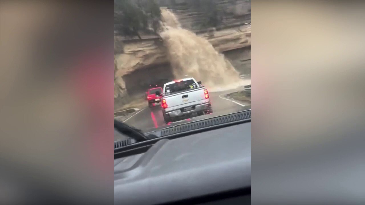 Indiana waterfall gushes with floodwater over cars