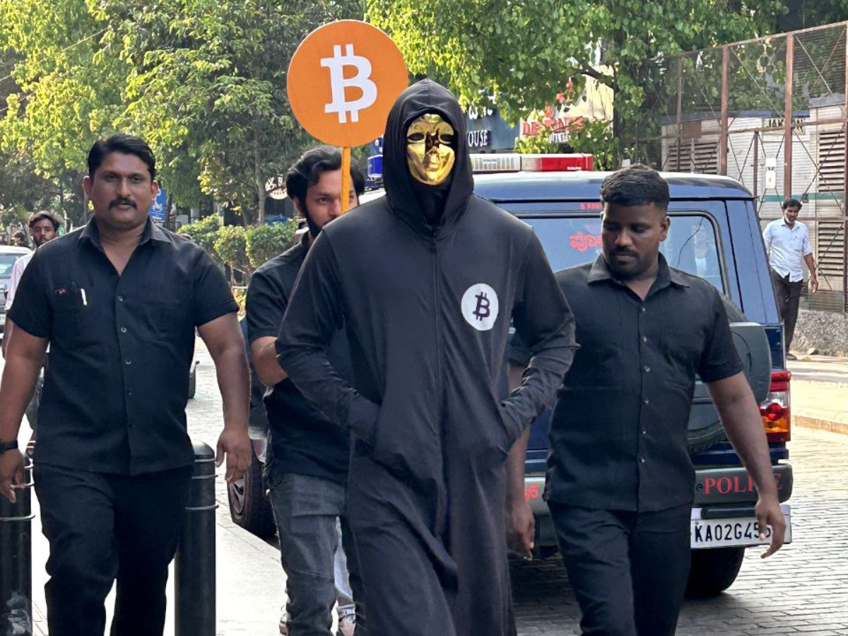 Golden mask, zero words: Satoshi Nakamoto ‘appears’ in Bengaluru on ...