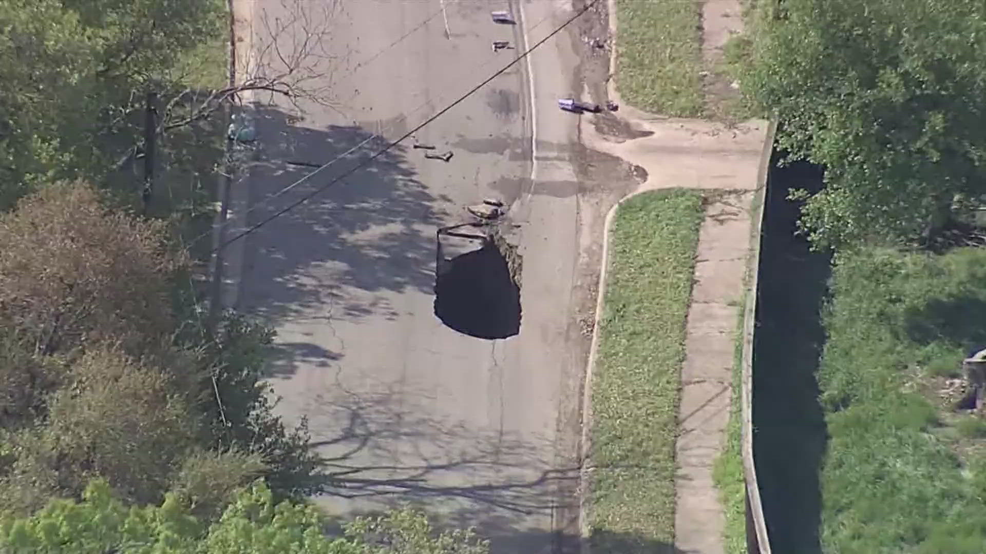 Truck gets stuck in sinkhole on Dallas road after wastewater pipe breaks