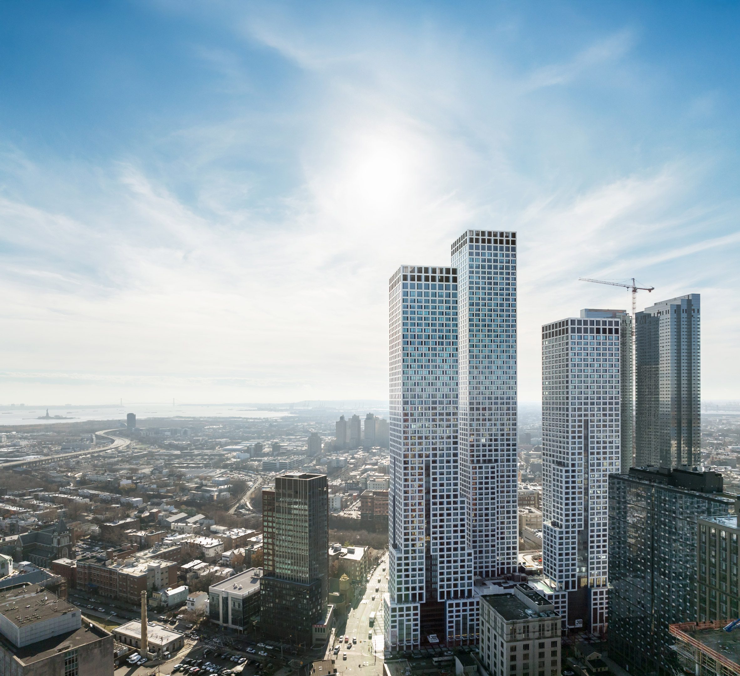Three connected white-clad skyscrapers completed in New Jersey