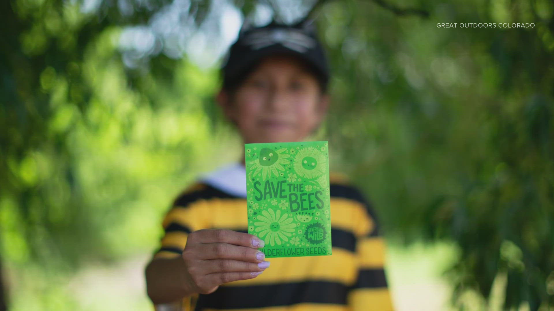 Generation Wild handing out wildflower seed packet to kids